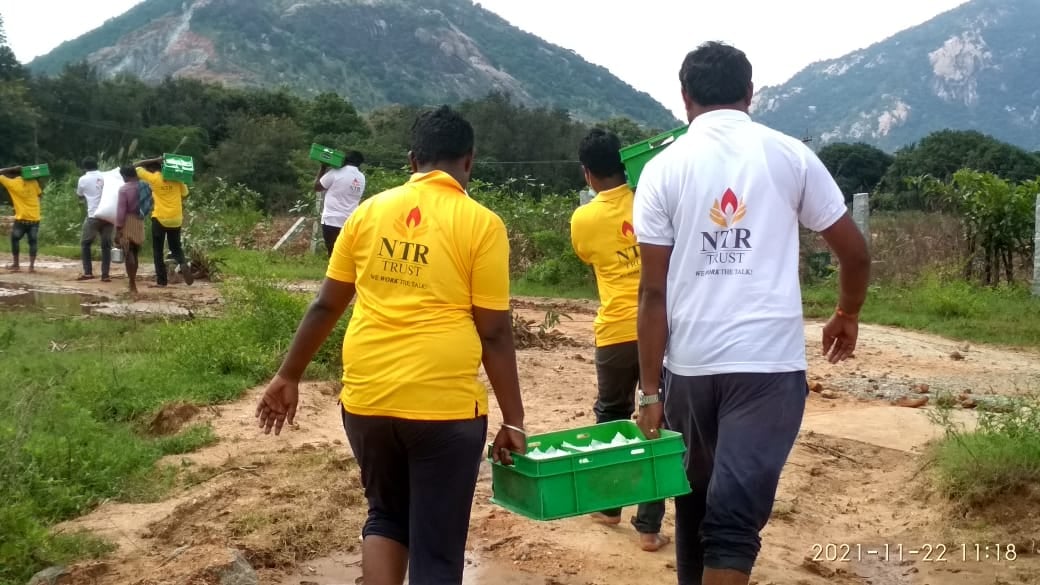 NTR Trust volunteers are seen crossing the Mondi Kalva River in ...